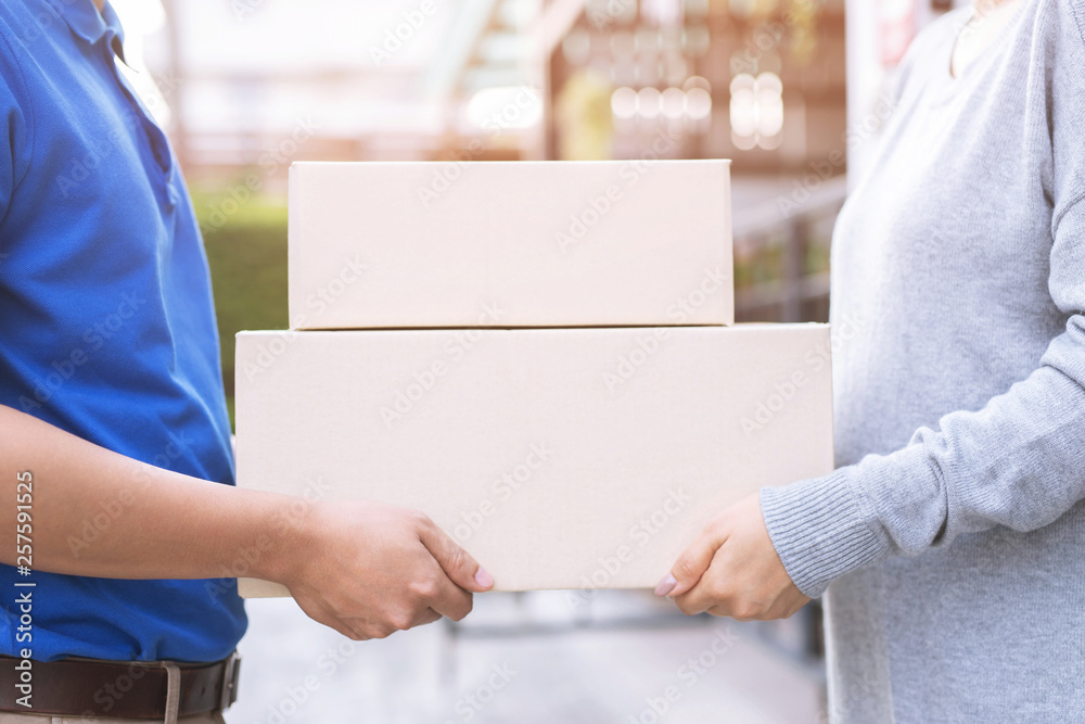parcel delivery man of a package through a service. and close up hand ...