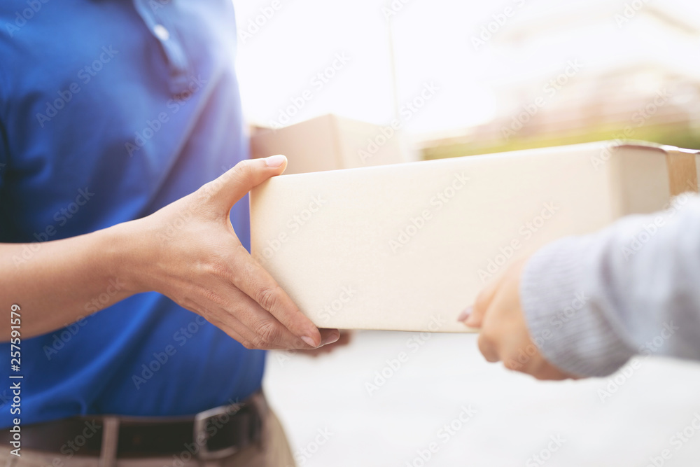 parcel delivery man of a package through a service. and close up hand ...