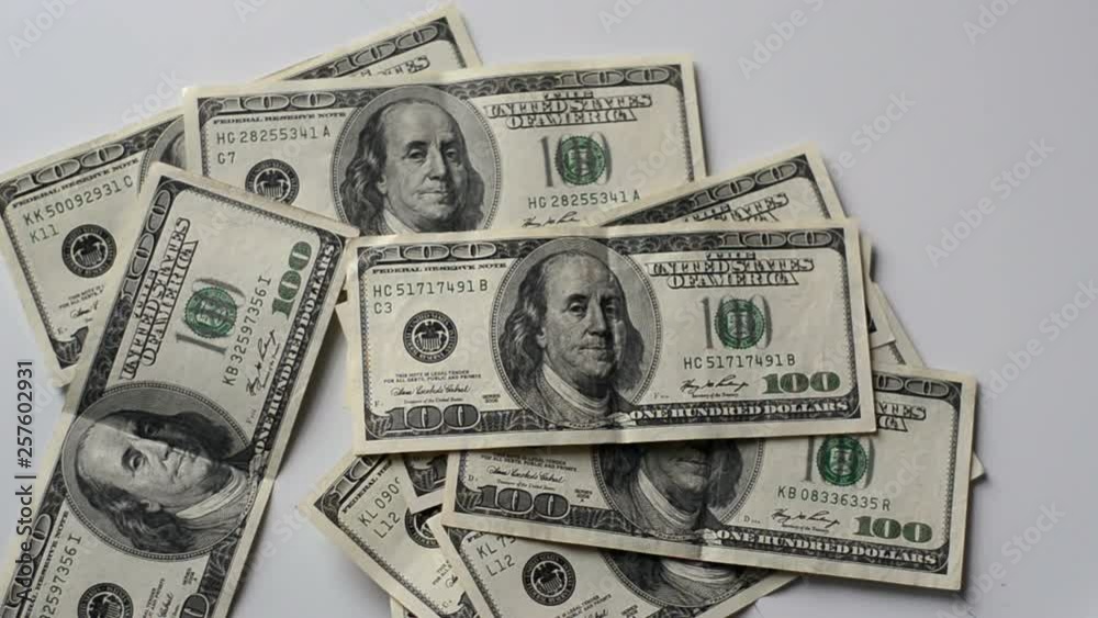Person throws the hundred dollar banknotes on a floor. Money background ...