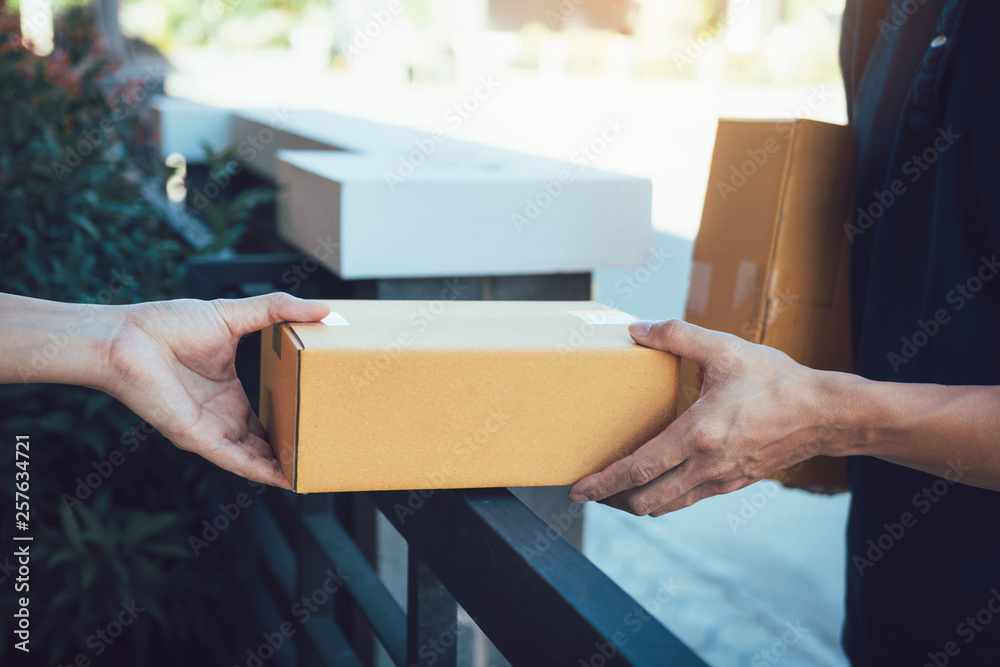 Asian smart man handing giving a package to a customer. Stock Photo ...