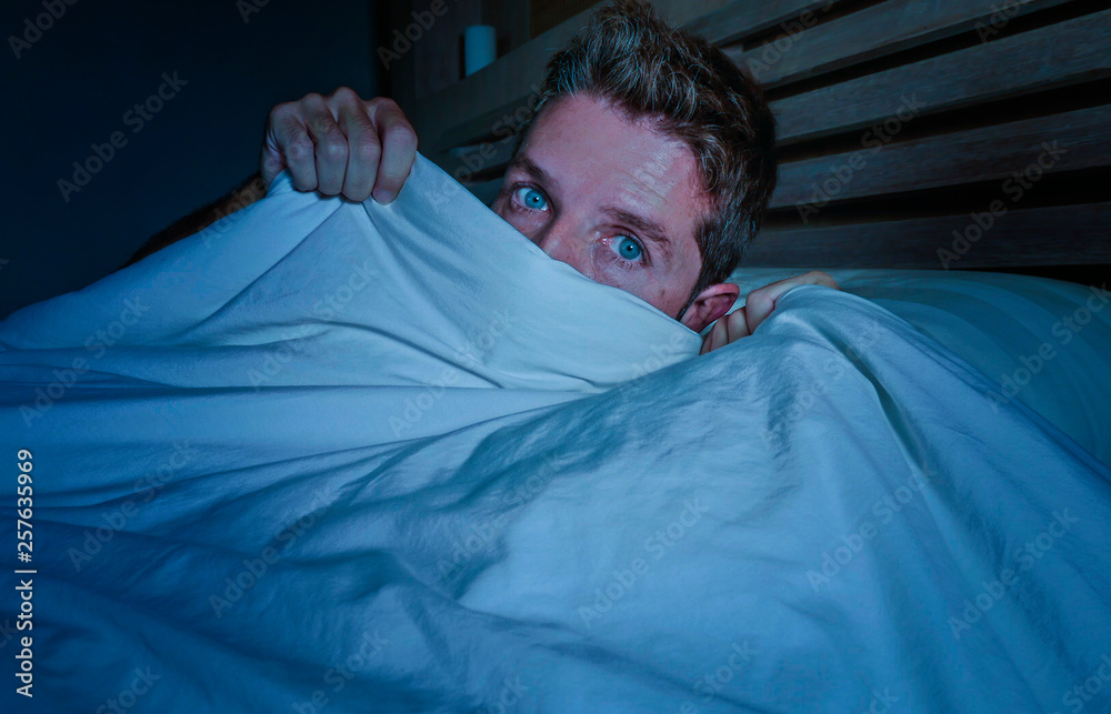 portrait of young attractive scared man in fear and panic suffering ...