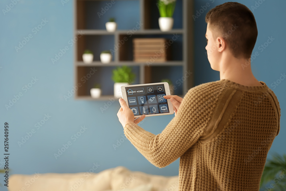 Teenage boy using application of smart home automation Stock Photo ...