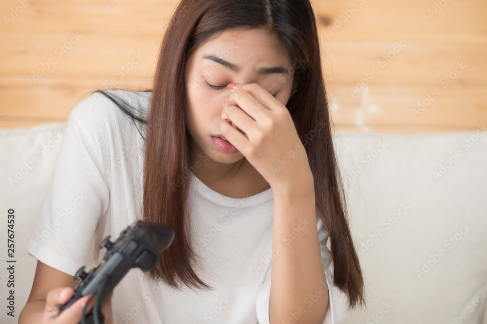 woman with eye problem due to video game. portrait of asian woman ...