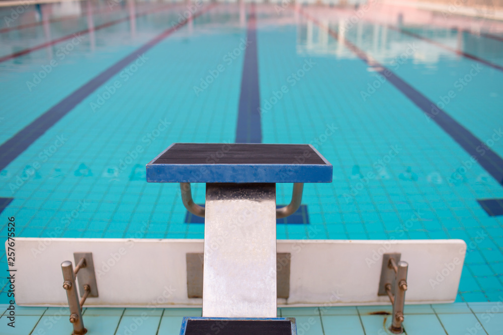 Starting blocks in row by the swimming pool, selective focus. Jump ...