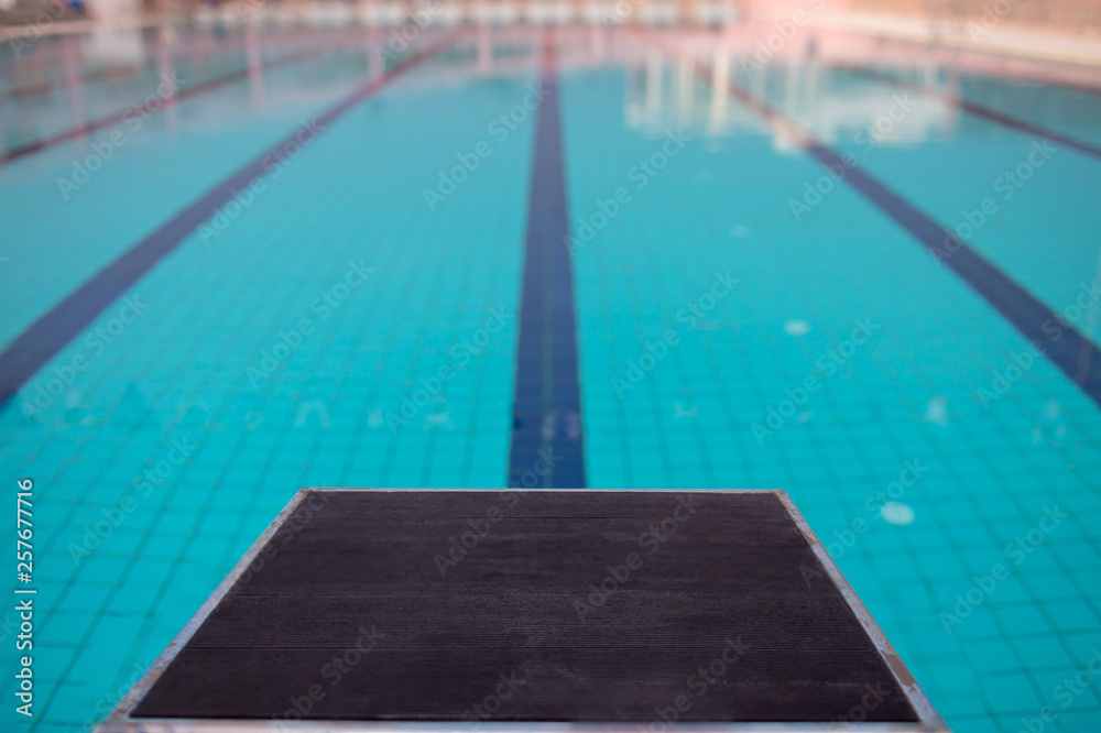Starting blocks in row by the swimming pool, selective focus. Jump ...