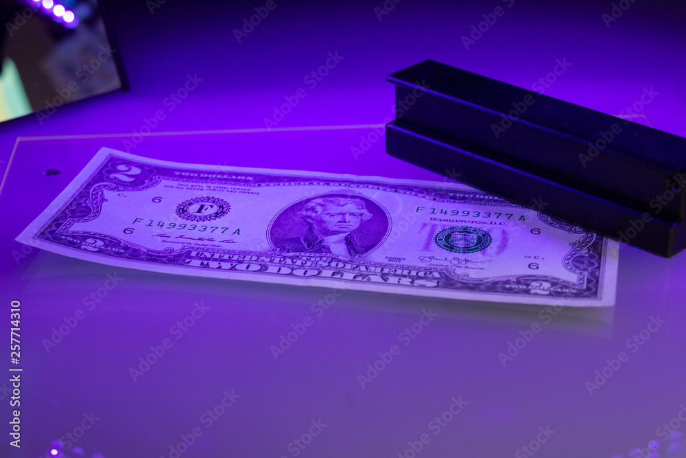 Verifying the authenticity of the two-dollar bill in ultraviolet light ...