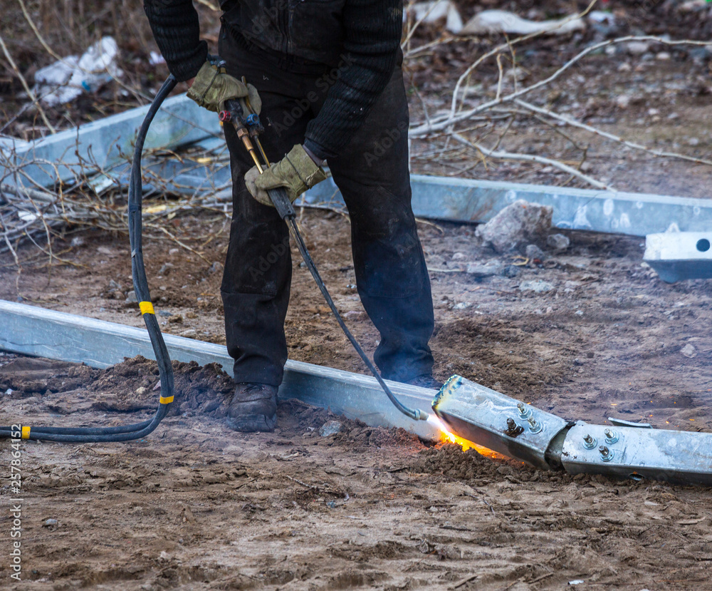 A worker cut steel beams using propane-oxygen torch..Oxy-fuel cutting ...