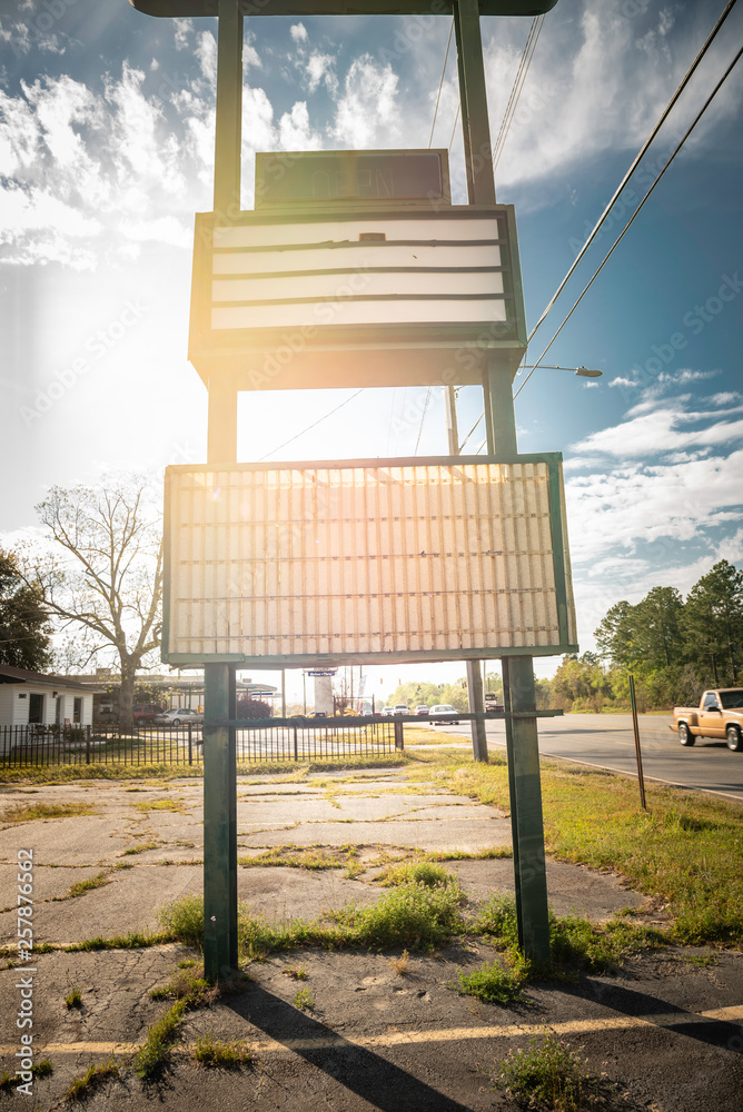 An old, dilapitated and empty changeable letter sign board on a street ...