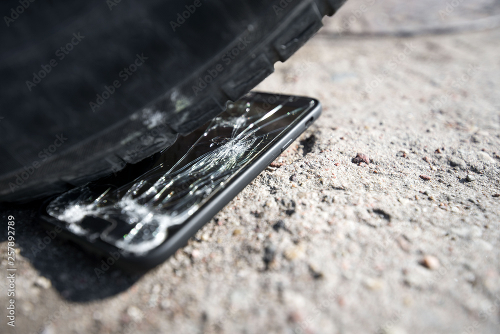 Broken and damaged smartphone with cracks on glass screen laying on ...
