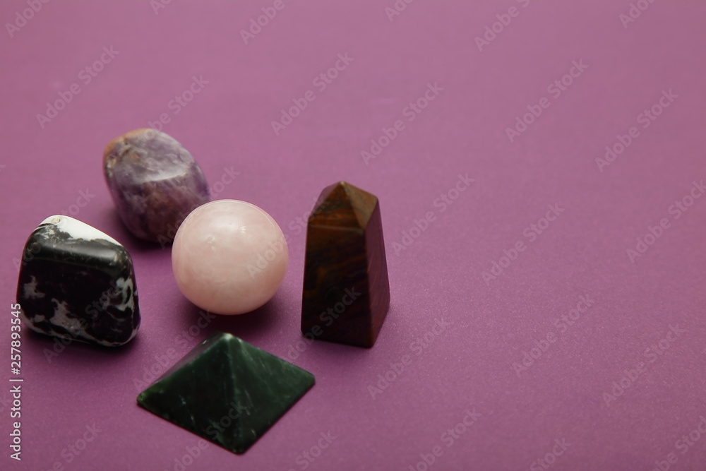 Magic stones and crystals of different shapes and colors lying in bulk ...