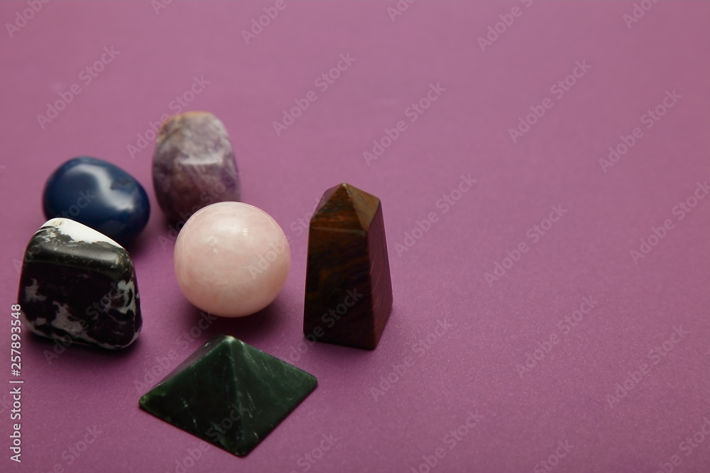 Magic stones and crystals of different shapes and colors lying in bulk ...