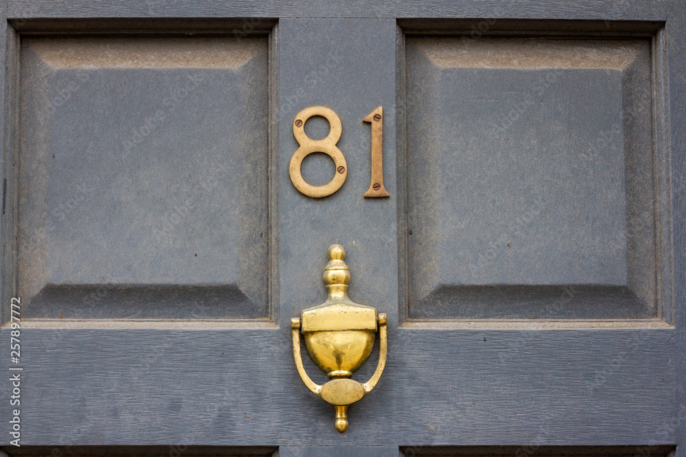 House number 81 with the eighty-one in bronze and a bronze metal shiny ...