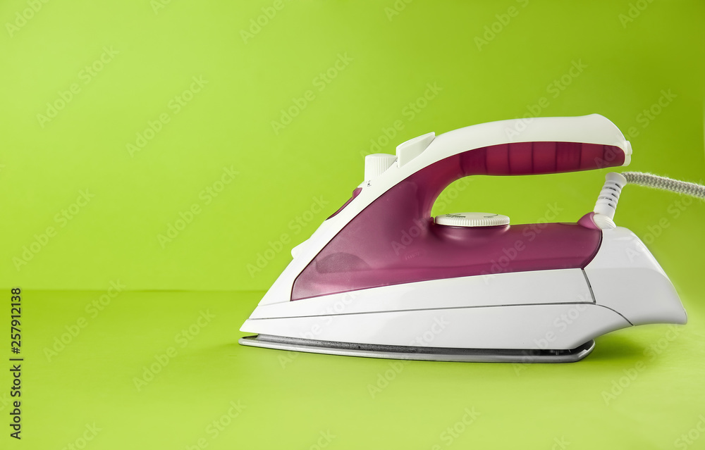 Modern iron on color background Stock Photo | Adobe Stock