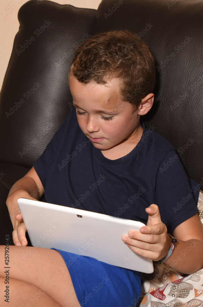 child with a tablet and a bump on the head Stock Photo | Adobe Stock