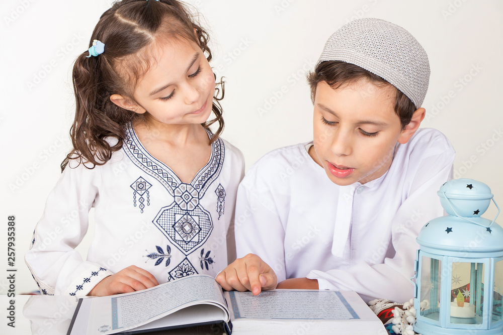 Muslim children reading holy Quran in Ramadan Stock Photo | Adobe Stock