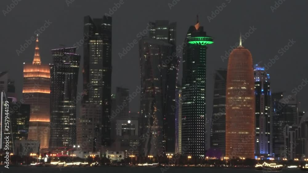 Doha West Bay skyline lighting by night in Doha Bay. Modern skyscrapers ...