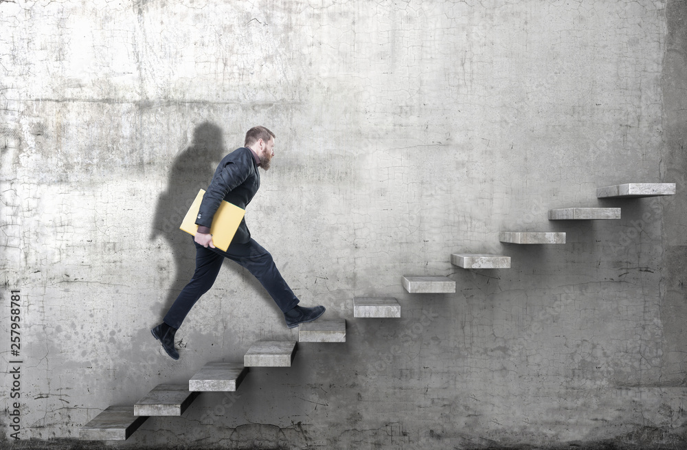 Side view of a man climbing up the steps in a blank concrete wall. 3d ...