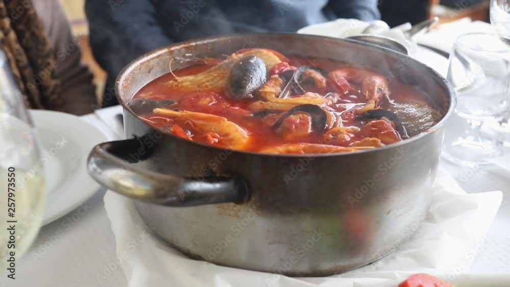 portuguese fish stew in big iron pot in restaurant Stock Video | Adobe ...