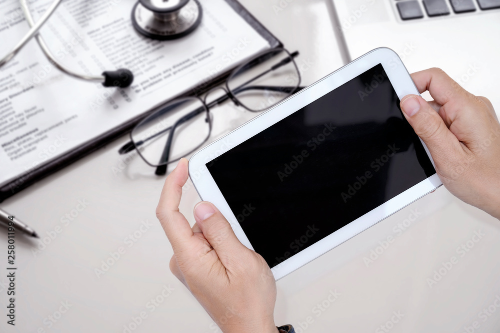 Shot of doctor hand holding tablet with black screen while working at ...