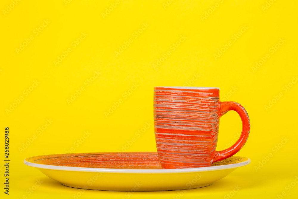 Table set of cups and plates on a yellow background Stock Photo | Adobe ...