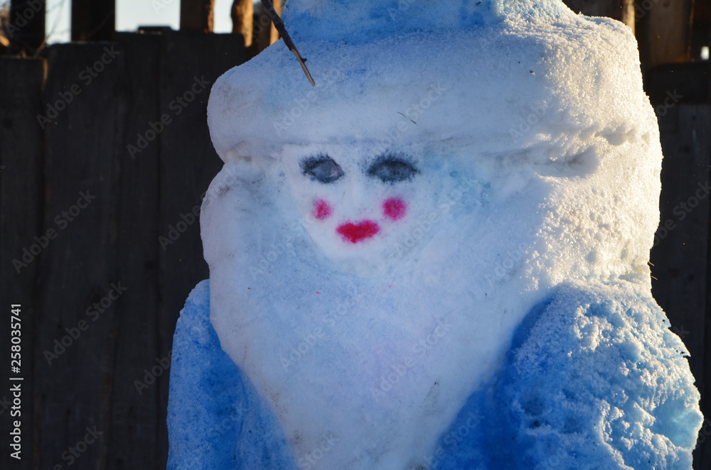 In the Ural villages in winter the owners set snow figures in front of ...