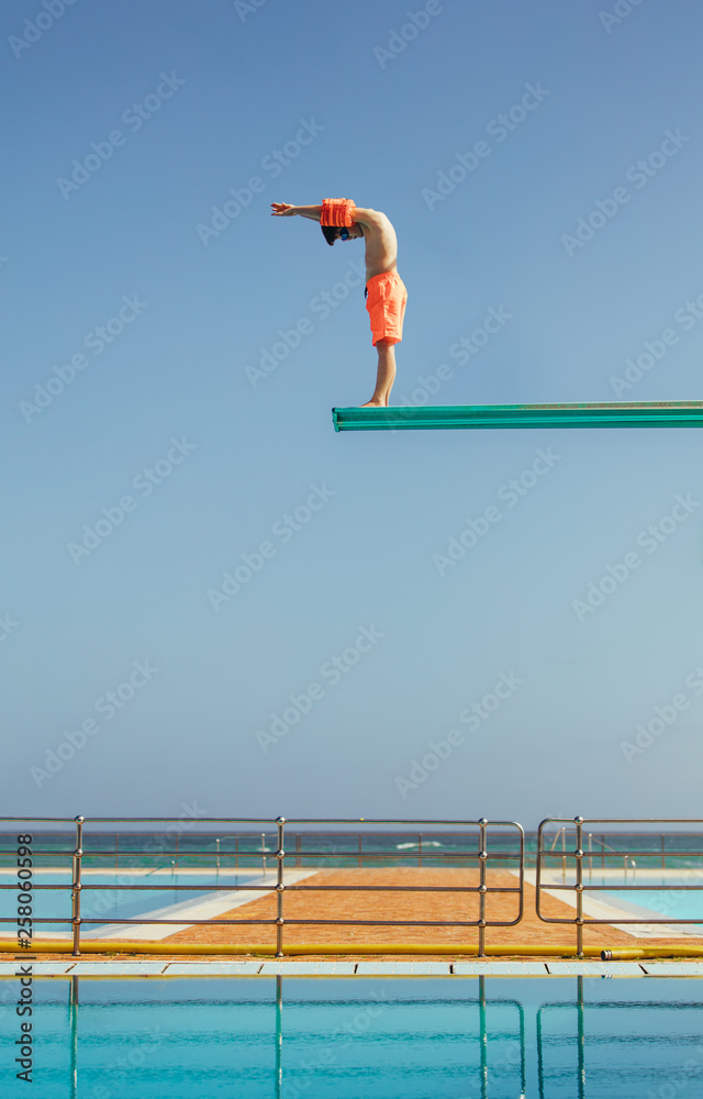 Boy ready to dive into pool Stock Photo | Adobe Stock