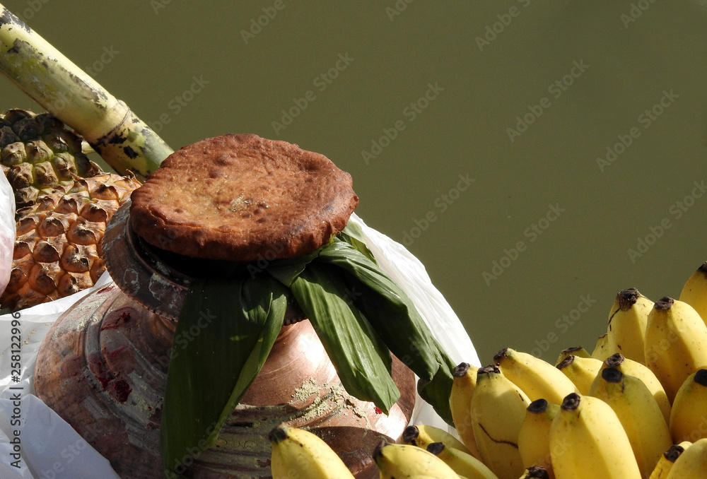 Food offerings by Hindu woman to pray sun God, at dusk,in the bank of ...