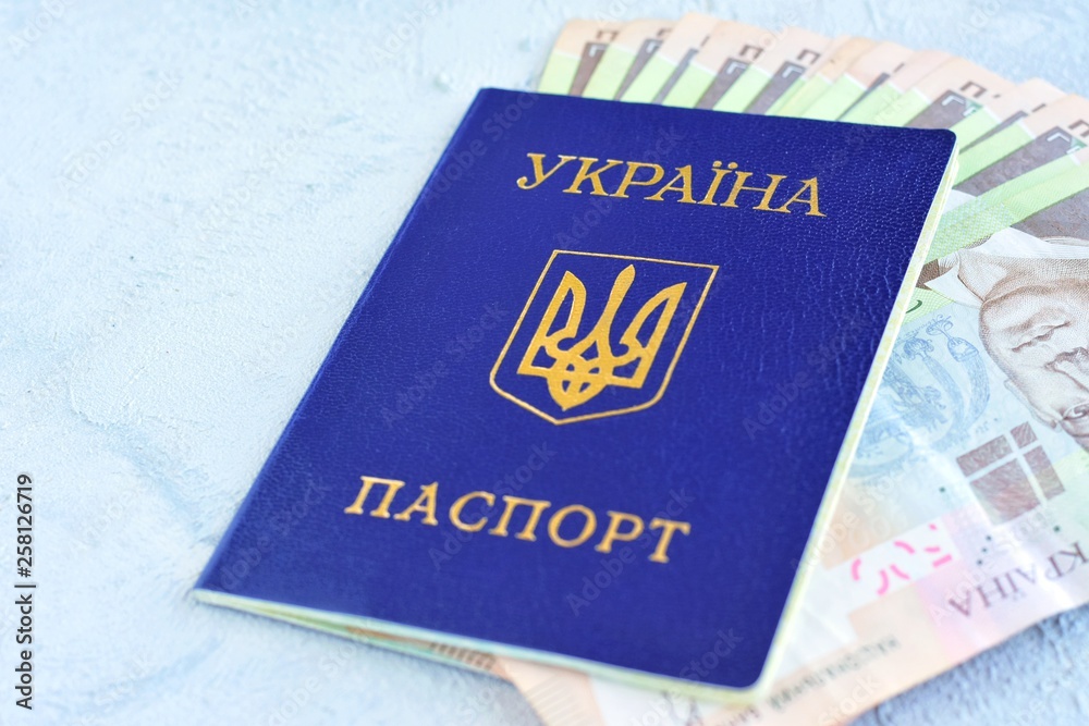 Internal passport of Ukraine with the national currency hryvnia inside ...