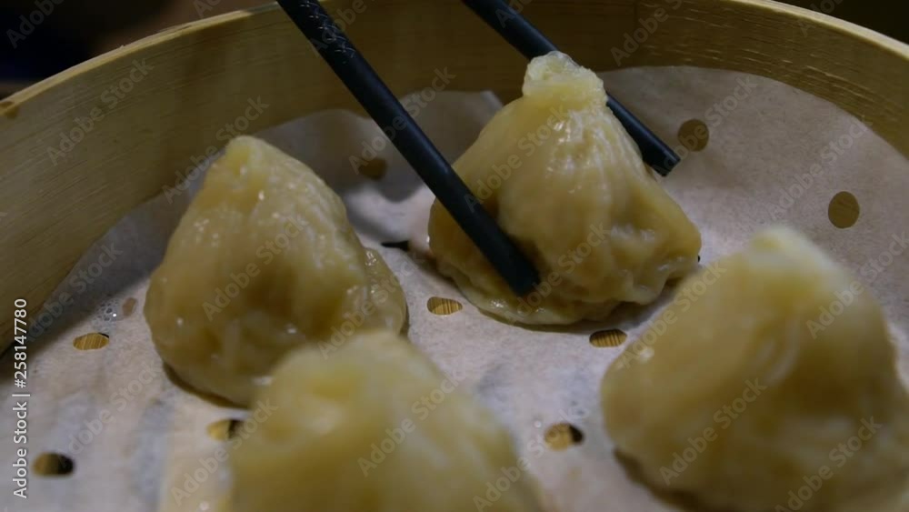 Slow Motion of using chopsticks for eating dumplings in a restaurant ...
