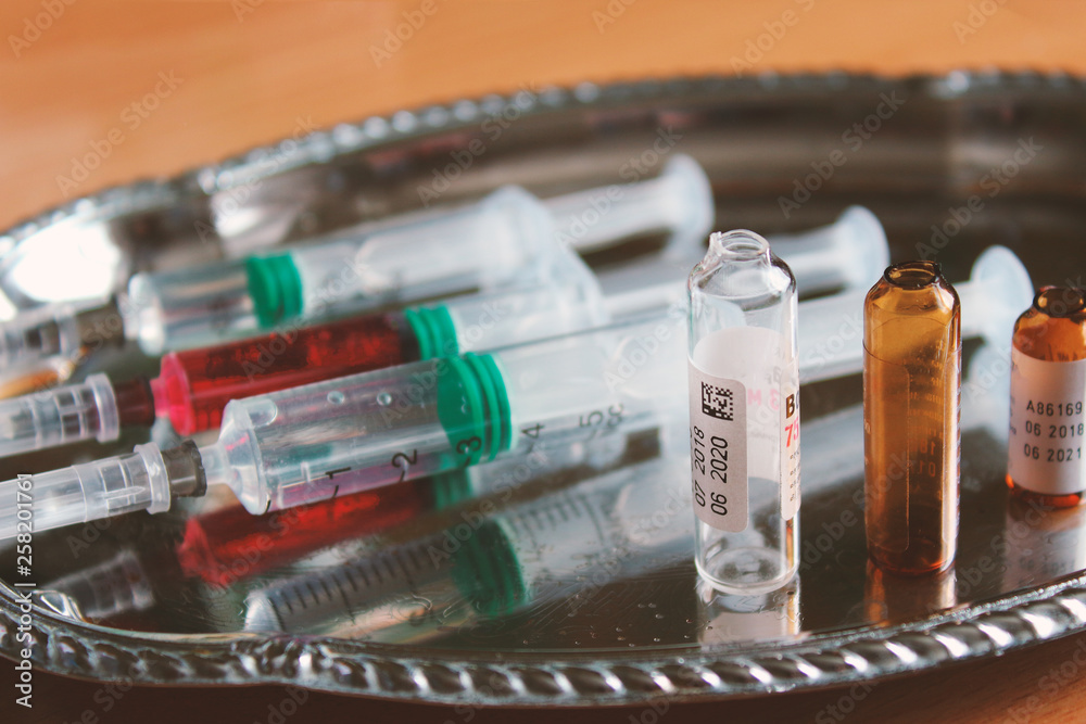 Syringes lying on a tray. Close-up. Background. Texture. Stock Photo ...