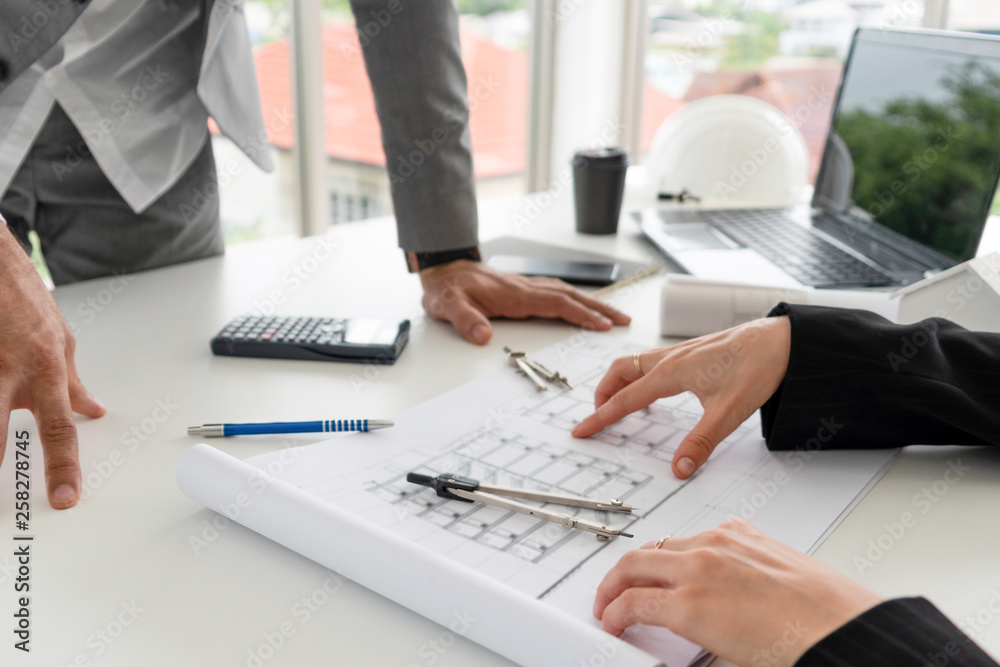 Architect and engineer working with construction drawing project on ...