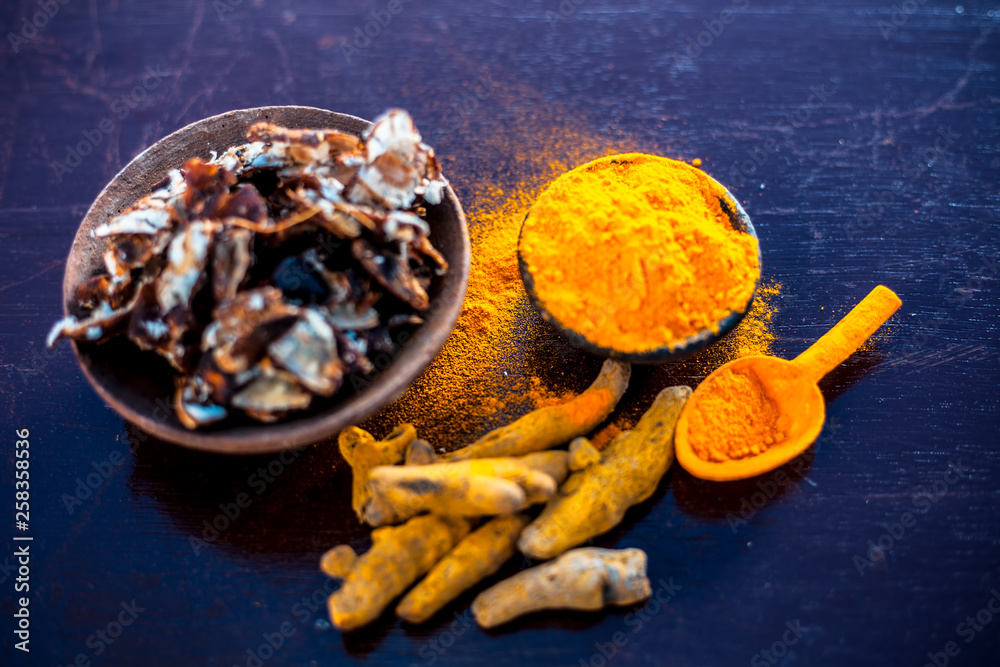 Tamarind or imli or amli in a clay bowl along with its roasted seeds on ...