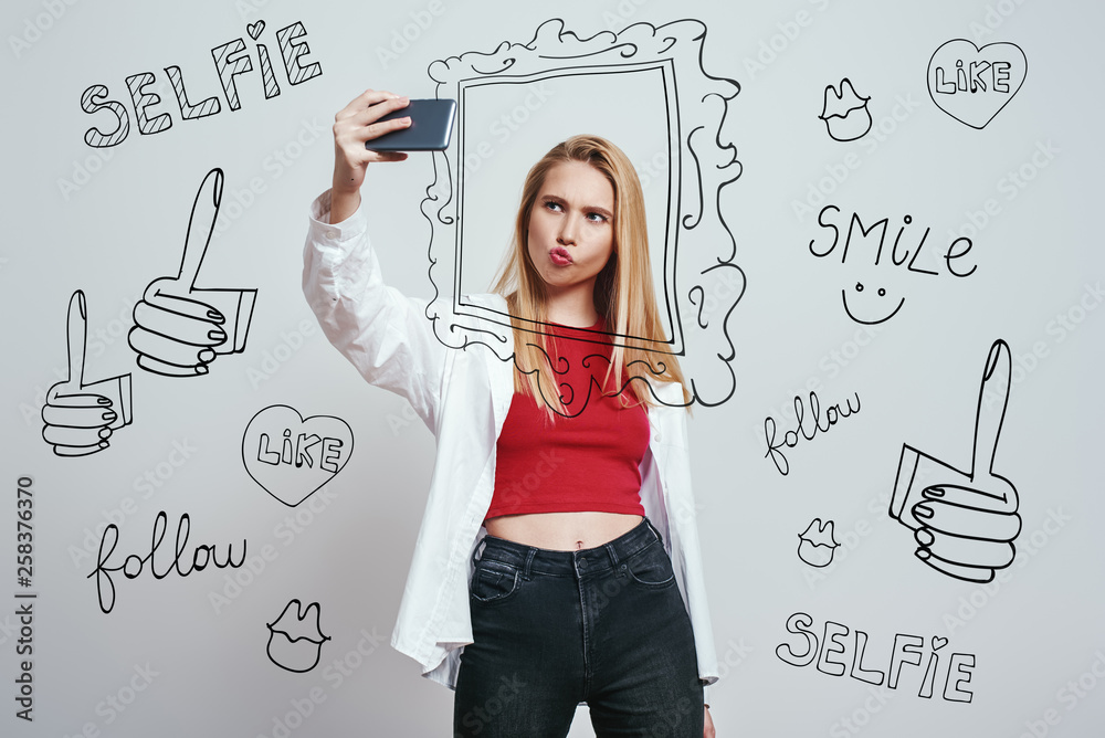 Selfie time! Pretty young woman with long hair making selfie by her ...