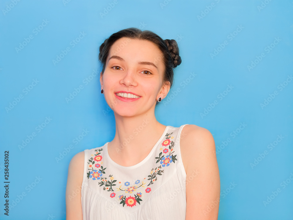 Funny cute girl on a blue studio background. Bright emotional female ...