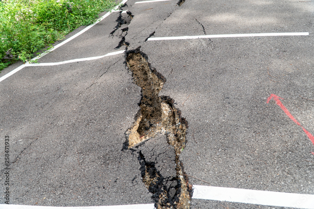 Damaged the road collapses with huge cracks by natural disaster ...