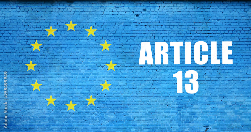Article 13 inscription and european union flag on blue brick wall ...