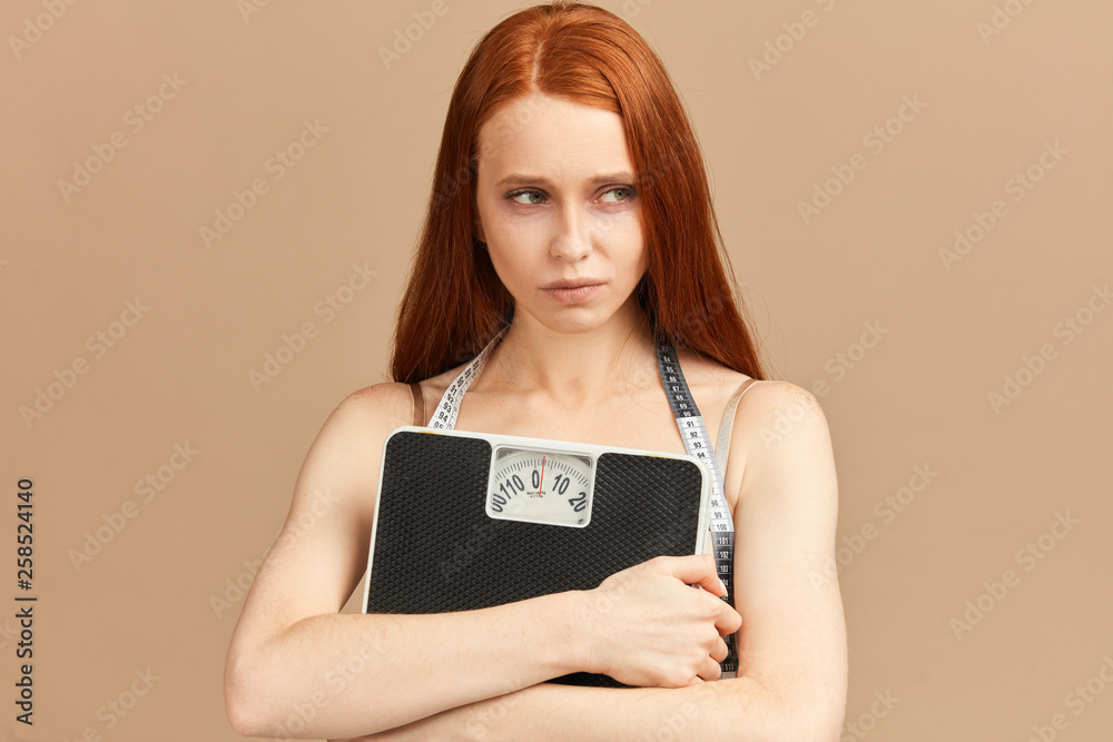 Diet and weight, young frustrated woman, looking aside, feeling ...