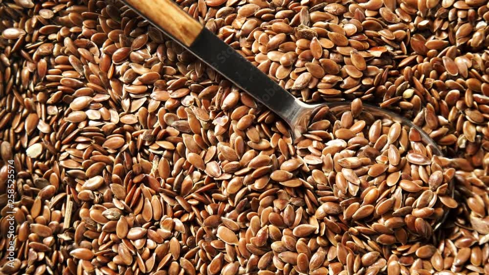 Brown raw flax seeds linseed as natural food background or grain texture. Flaxseeds full of ...