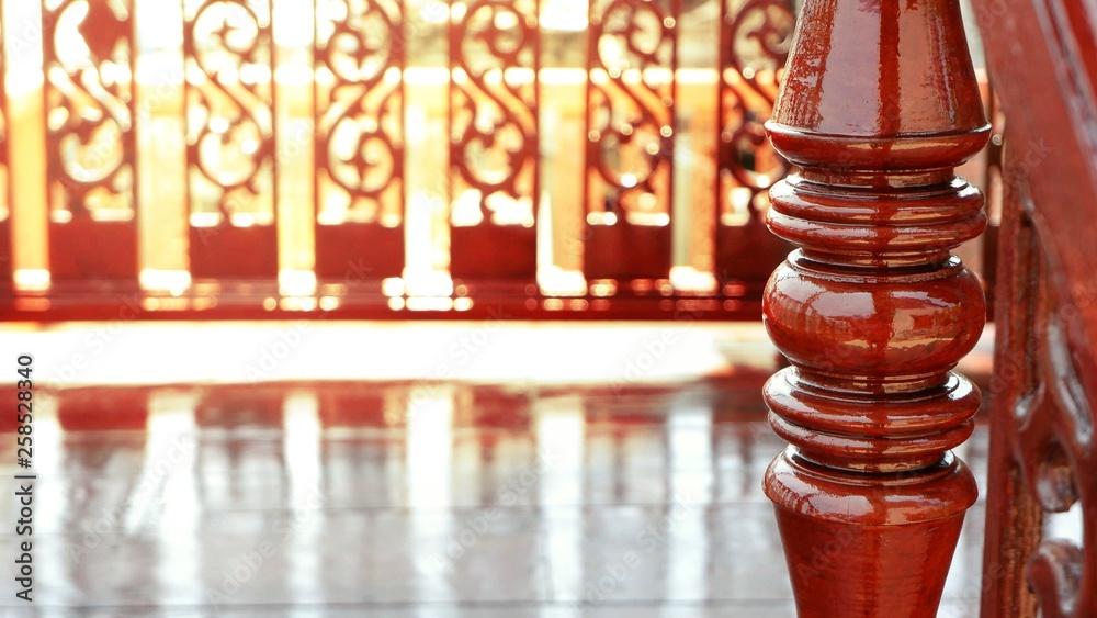 Vintage glossy wooden newel post with flare light and reflection on ...