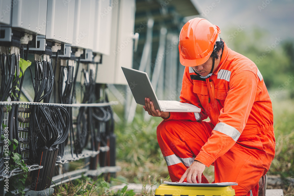 engineer or electrician holding laptop for inspect and checking string ...