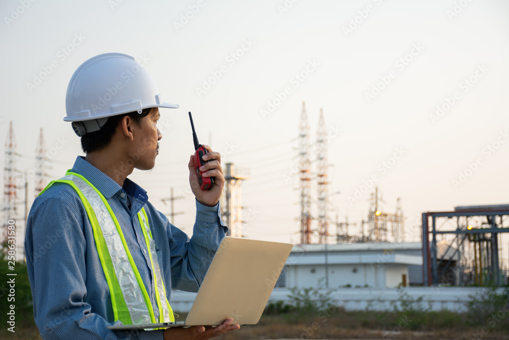 Engineers male working with laptop and operate the radio for workers ...