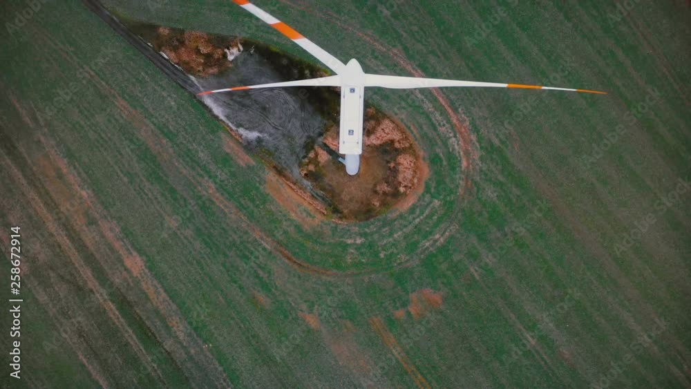 Top view drone slowly flying above working windmill turbine with red ...