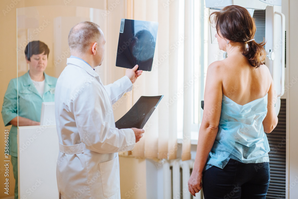 Male octor Standing Assisting Female Patient Undergoing Mammogram X-ray ...