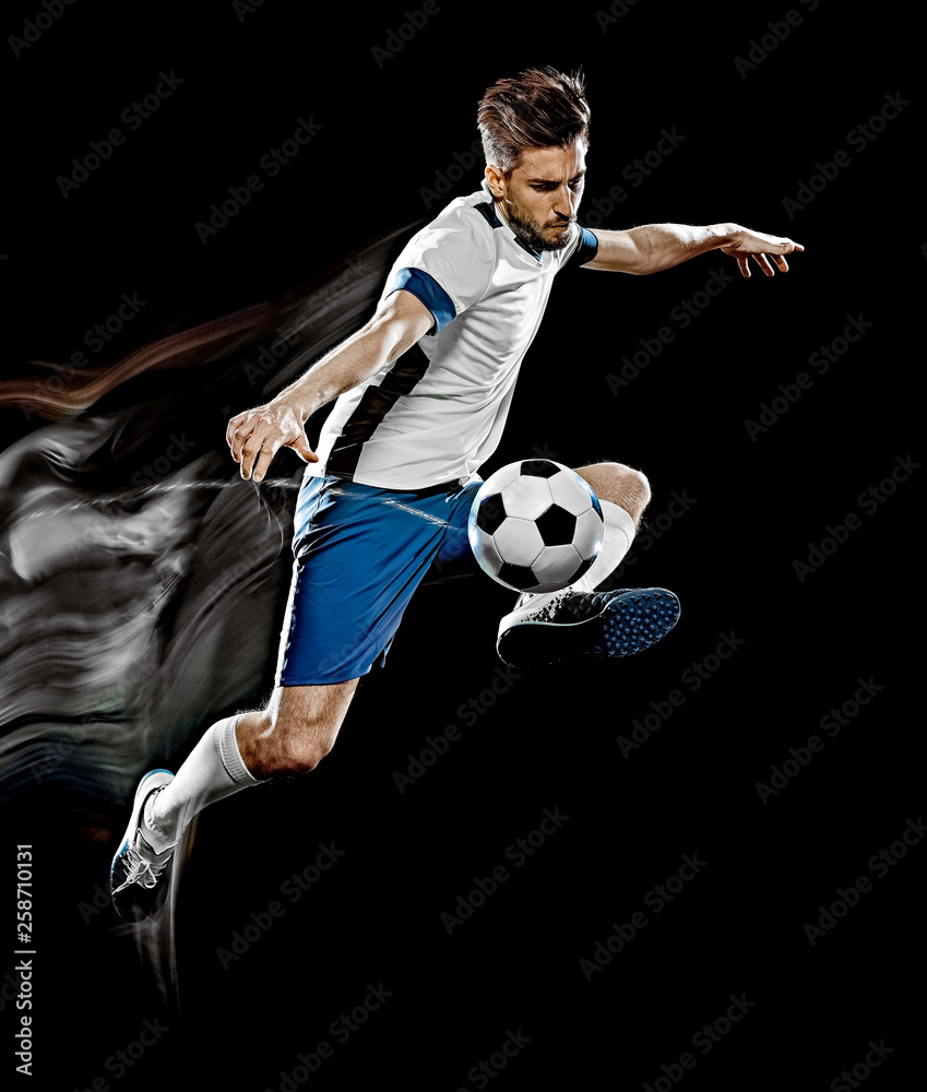 one caucasian soccer player man isolated on black background with light ...