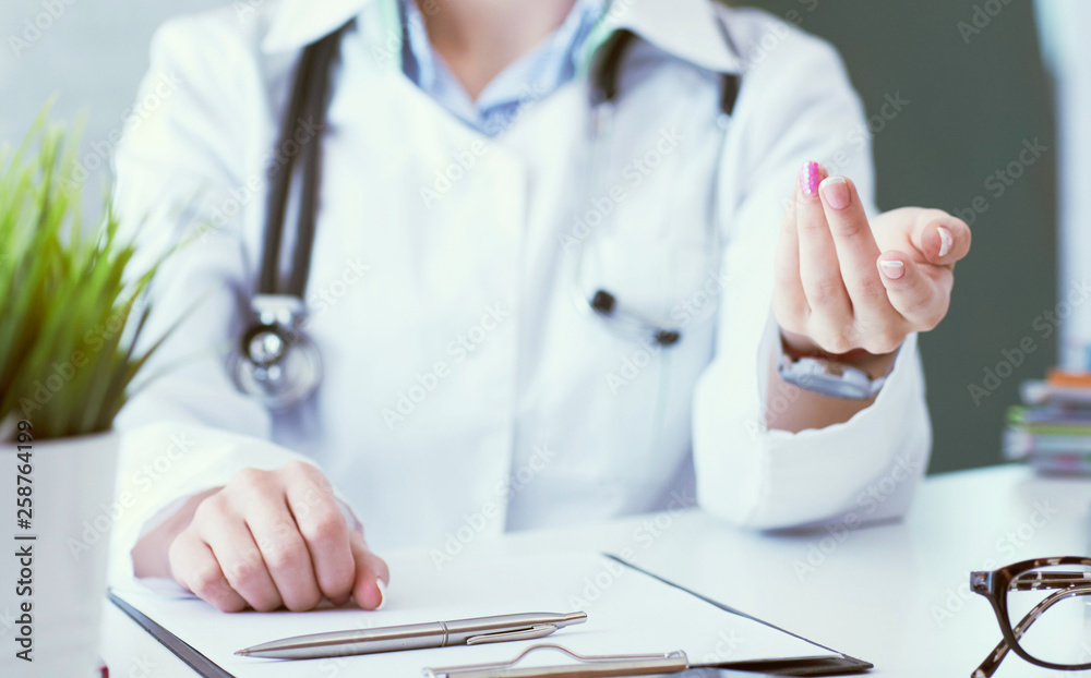 Female doctor explaining patient symptoms or asking a question as they ...