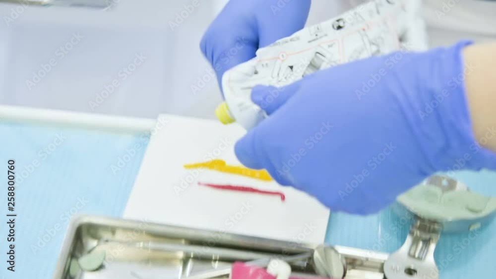 Close-up of the hand of dentistry mix components for a composite ...