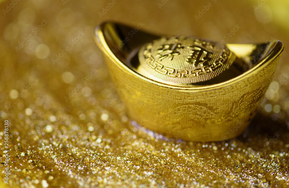 Chinese gold ingot on gold background Stock Photo | Adobe Stock