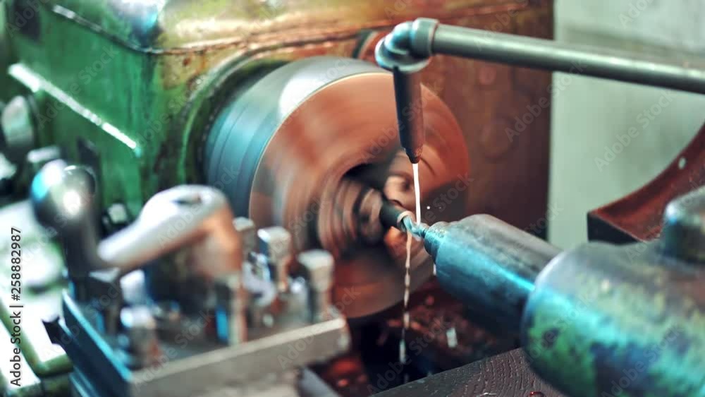 Process of cutting metal in turning lathe on the industrial factory ...