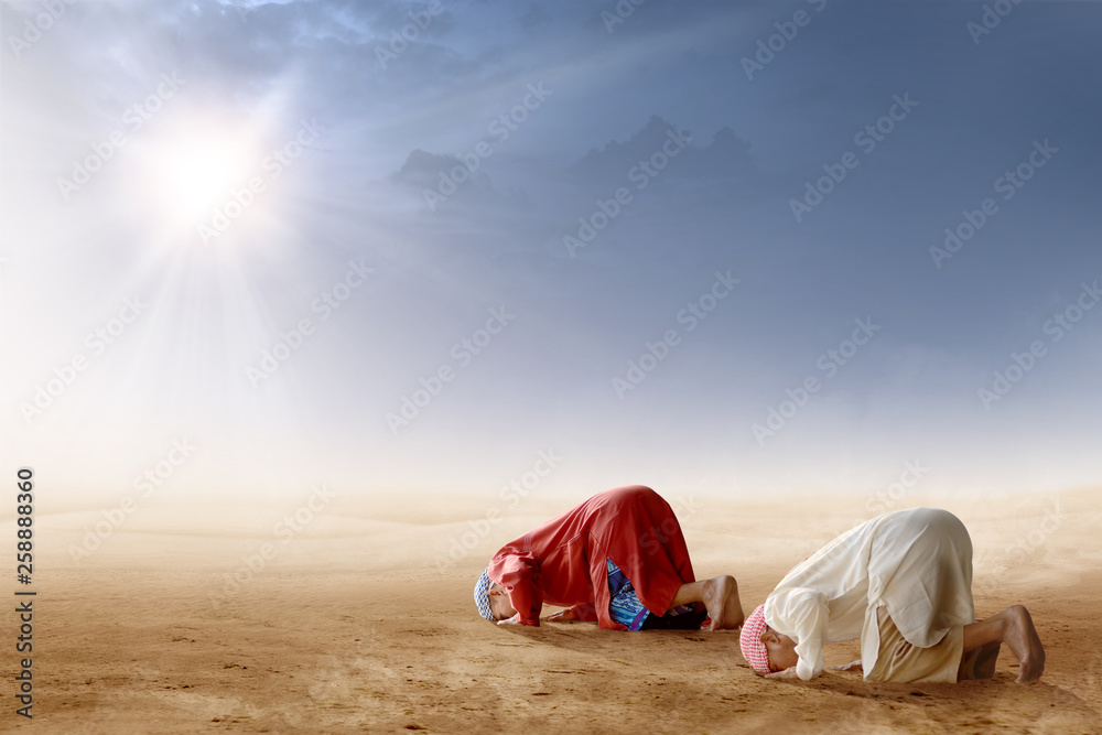 Rear view of two asian muslim man praying in prostration position on ...