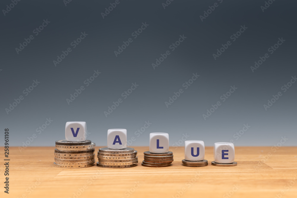 Symbol for decreasing value. Dice placed on stacks of coins form the ...
